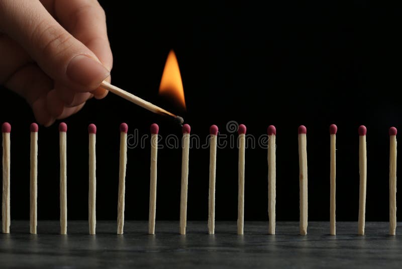 A woman igniting a candle stock image. Image of dark - 11495165