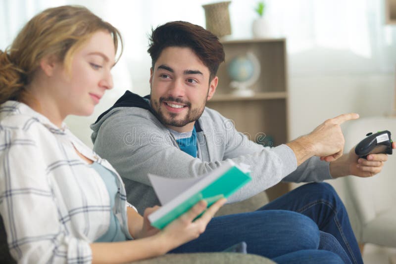 Woman Ignoring Boyfriend while she Reads Book Stock Image - Image of ...