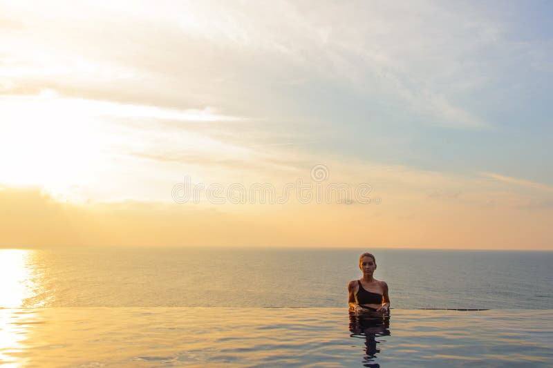 Woman at the Infinity Pool on Sunset Stock Image - Image of blue, pose ...