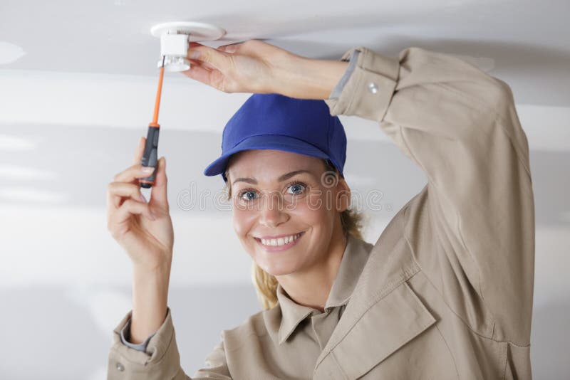 Woman Installing Light Bulb in Ceiling Stock Image - Image of home ...