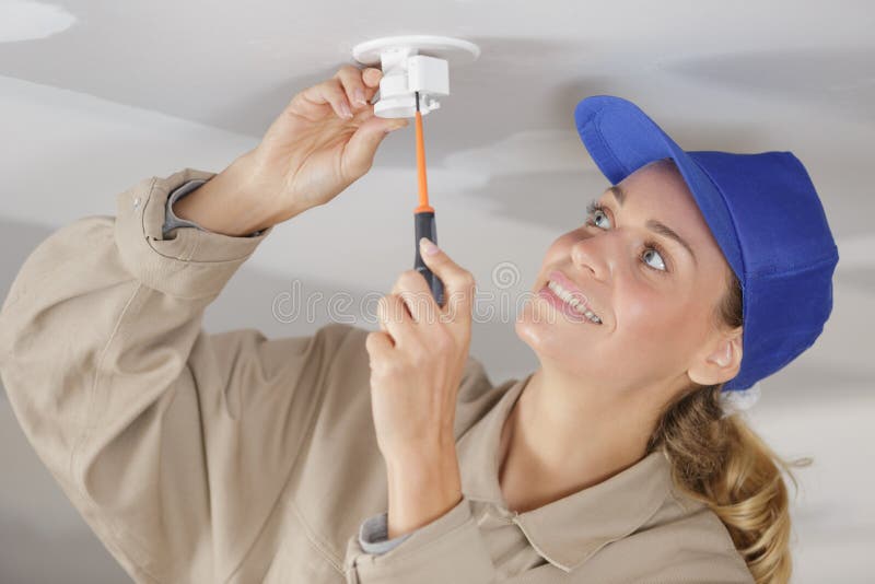 Woman Installing Light Fitting Stock Image - Image of electric, home ...
