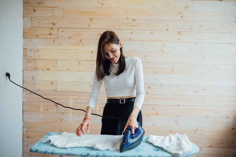 Housewife Woman Ironing Laundry on Ironing Board Stock Photo - Image of ...