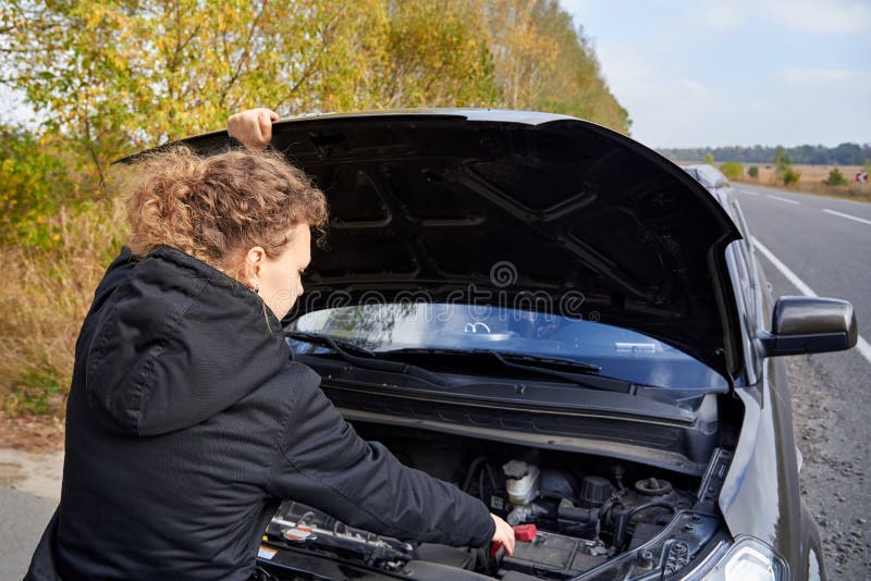 A Woman is Trying To Fix a Broken Car on the Road Stock Image - Image ...