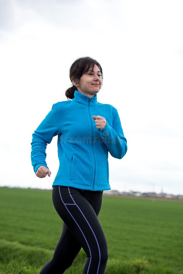 Woman jogging outdoors stock image. Image of beautiful - 70317785