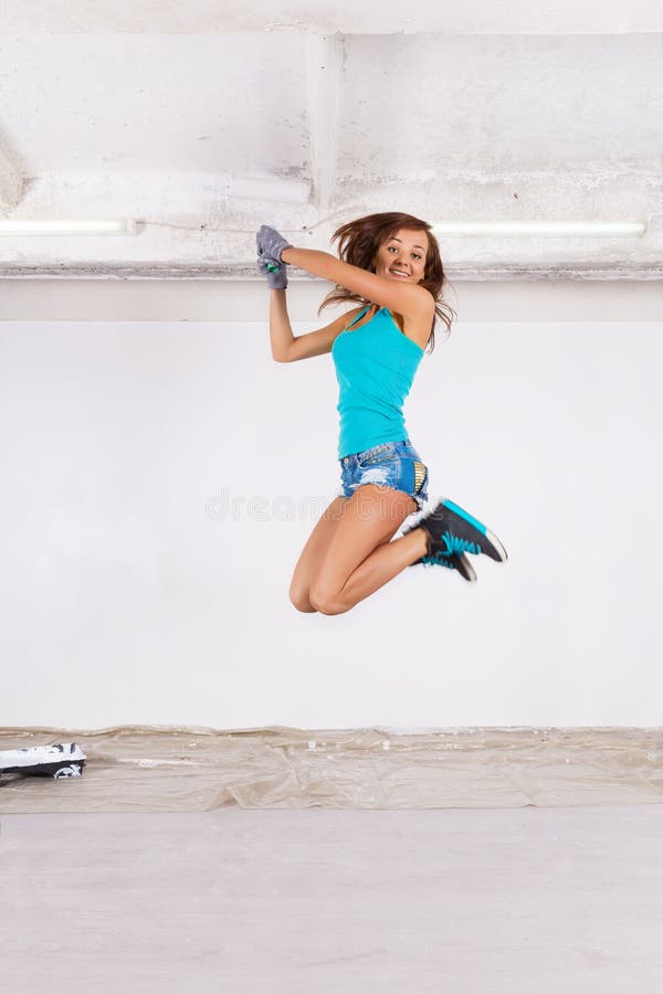 Woman Jump and Paints the Wall with White Paint Stock Image - Image of ...