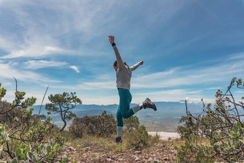Woman Jumping Over Rocks in Mountain Stock Image - Image of majestic ...