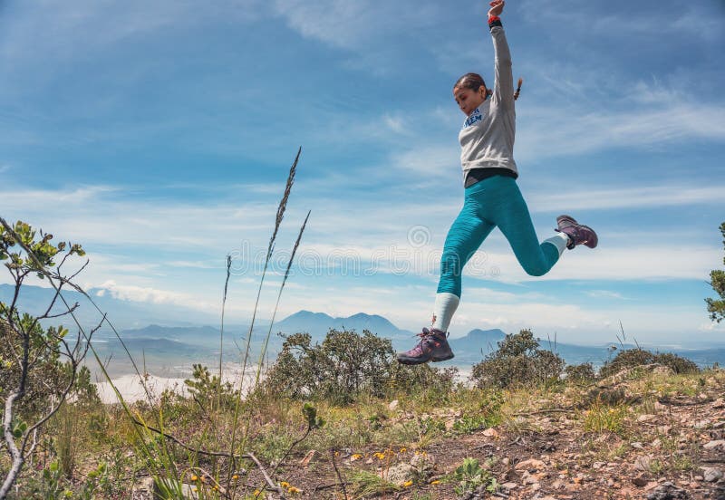 Woman Jumping Over Rocks in Mountain Stock Image - Image of ...
