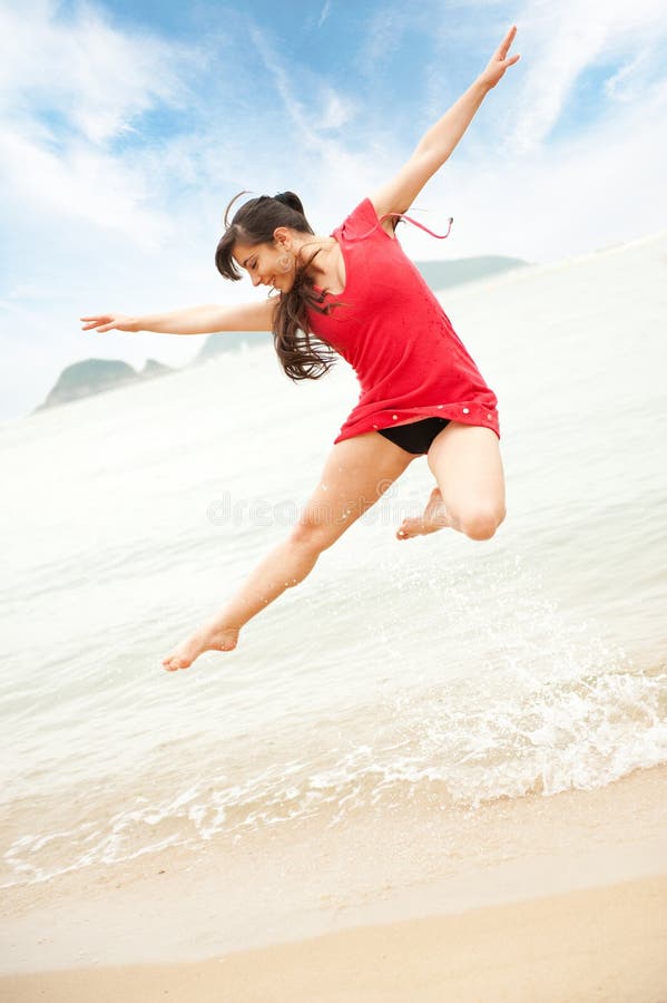 Woman jumping in the sea stock photo. Image of people - 11994460