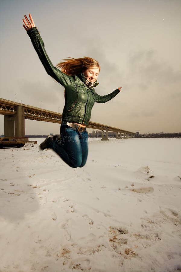 Woman jumping in snow stock photo. Image of fashion, scene - 13541786