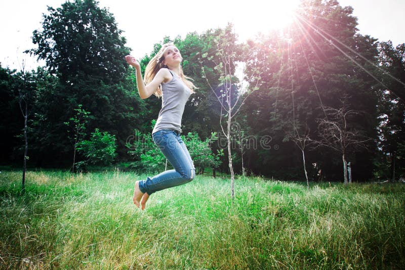 Woman jumps stock photo. Image of scene, leaf, gray, blue - 33205010