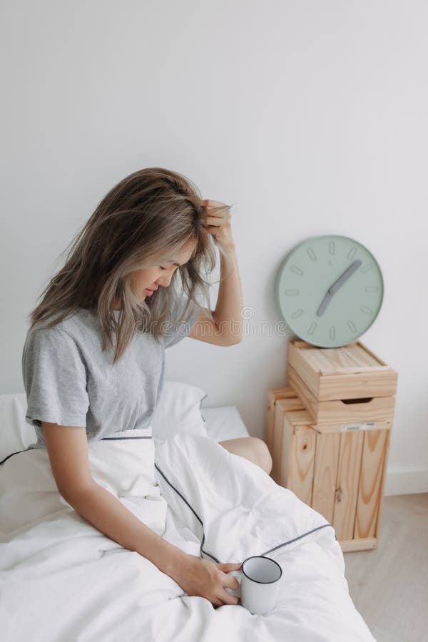 Woman Just Wake Up by the at Clock 7 am on the Bed in the Morning ...