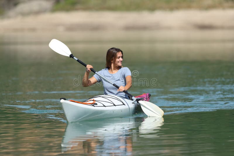 Woman Kayaking Looking at Side in a Tranquil Lake Stock Image - Image ...