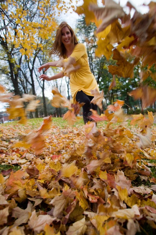 Woman kicks leaves stock photo. Image of play, twenties - 7060704
