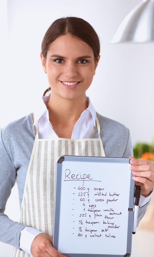 Woman in the Kitchen at Home, Standing Near Desk with Folder Stock ...