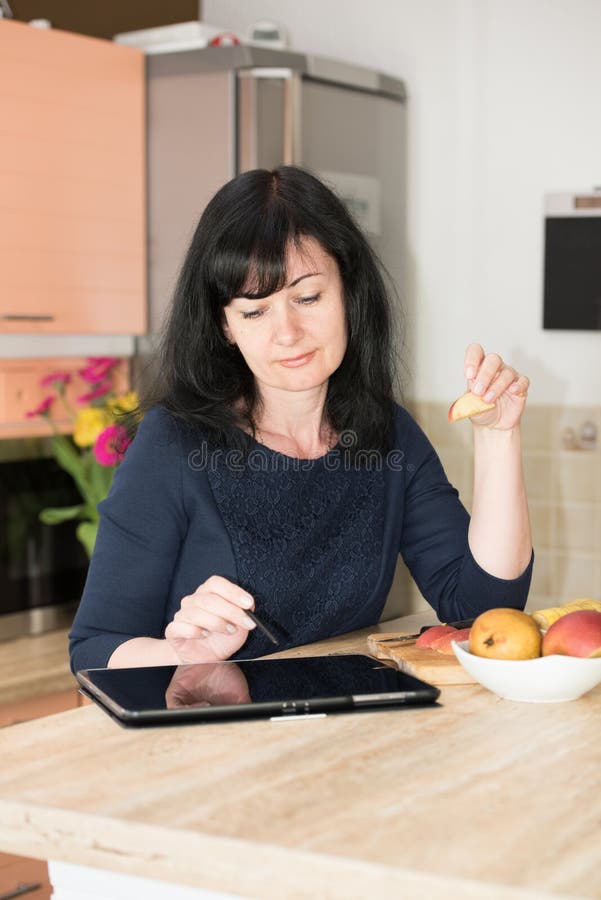 Woman in the Kitchen with Tablet Stock Image - Image of searching ...