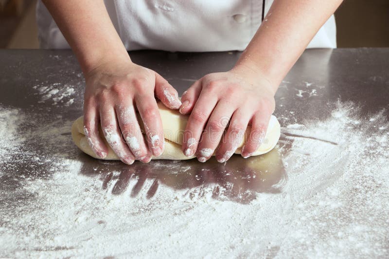 Woman Knead the Dough in Bakery, on a Table from Steel. Working Process ...