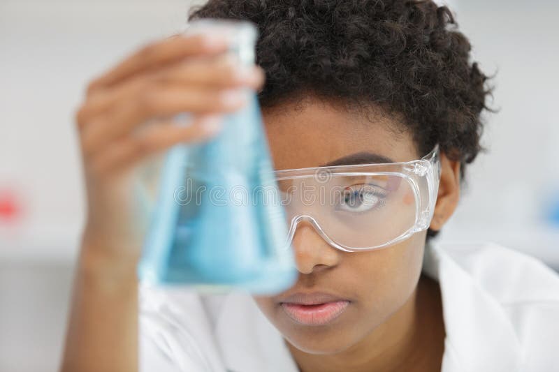 Woman in lab holding flask stock photo. Image of face - 288845952