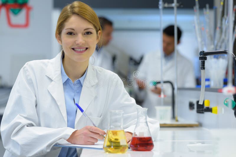 Woman in Lab Looking at Camera Stock Photo - Image of professional ...