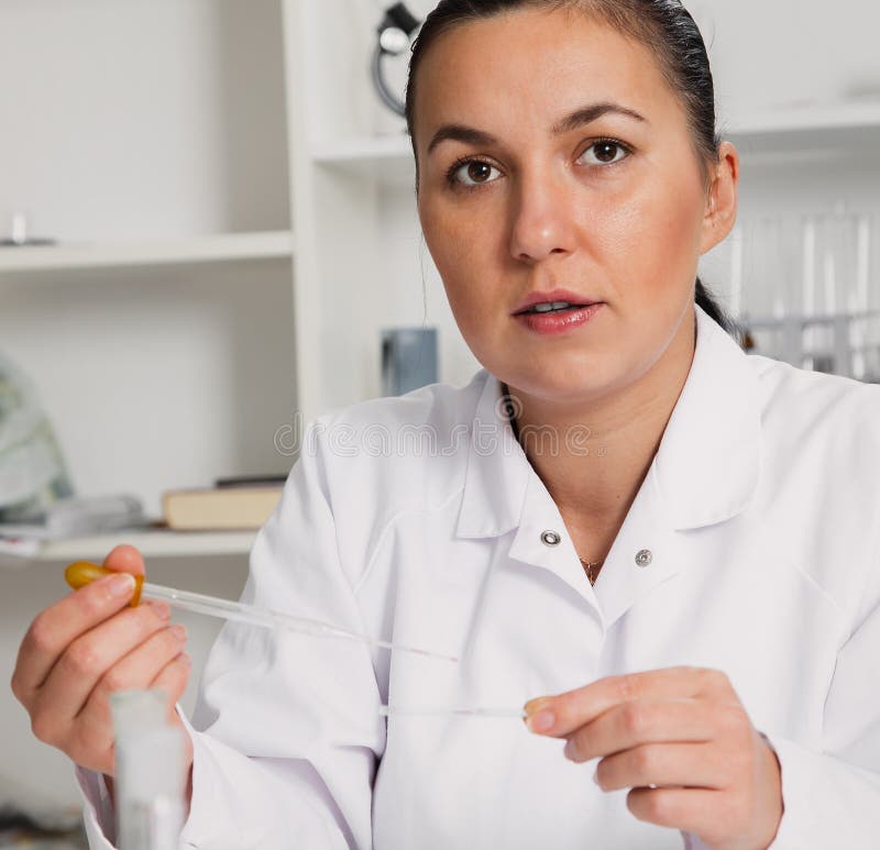 Woman in a Laboratory Microscope with Microscope Slide in Hand.toned ...