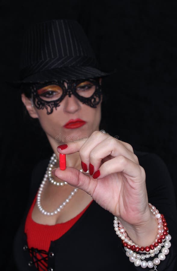 Woman in Lace Mask and Fedora Holding Red Pill Stock Image - Image of ...