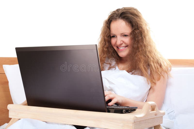 Woman with laptop in bed stock image. Image of tray, isolated - 23672105
