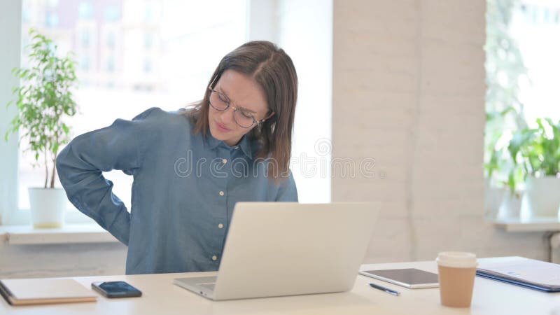 Woman with Laptop Having Back Pain in Office Stock Photo - Image of ...