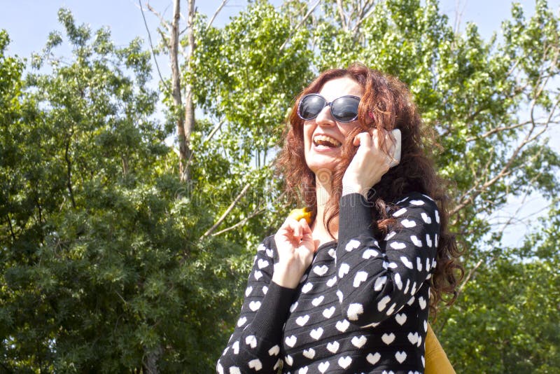 Woman Laughing while Talking Bay the Phone Stock Photo - Image of ...