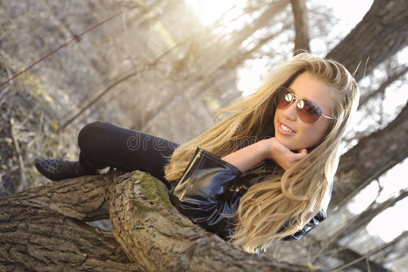 Woman lay on a tree trunk stock image. Image of female - 14230055