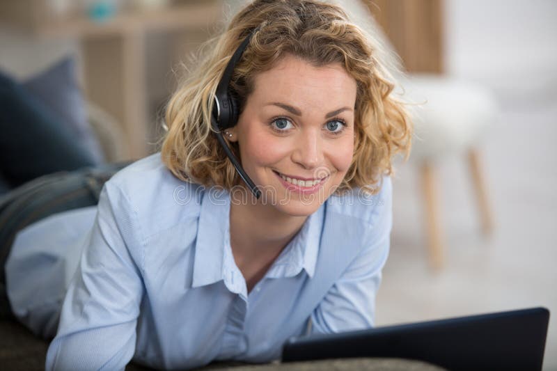 Woman Layed on Sofa Using Laptop and Wearing Headset Stock Image ...