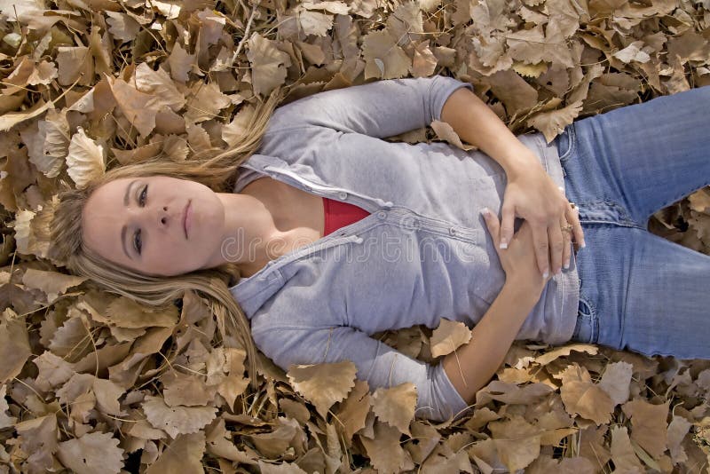 Woman Laying On Back In Leaves Royalty Free Stock Image - Image: 11730286