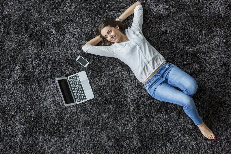 Woman laying on the carpet stock photo. Image of tranquil - 44074402