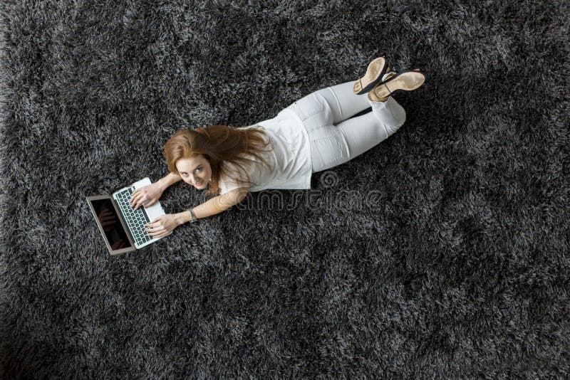 Woman laying on the carpet stock photo. Image of phone - 54991682
