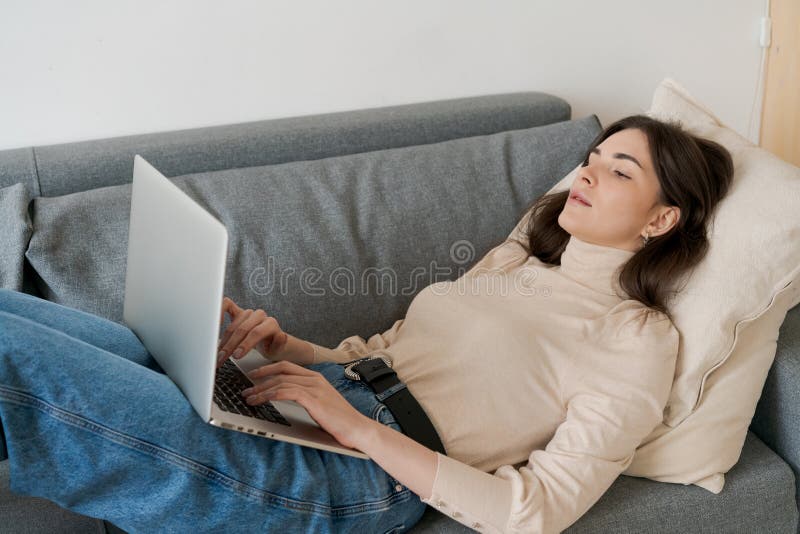 Woman is Laying on a Couch with a Laptop on Her Lap Stock Image - Image ...