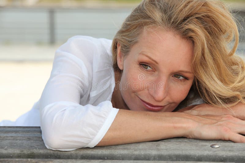 Woman leaning on a bench stock image. Image of leisure - 26938799