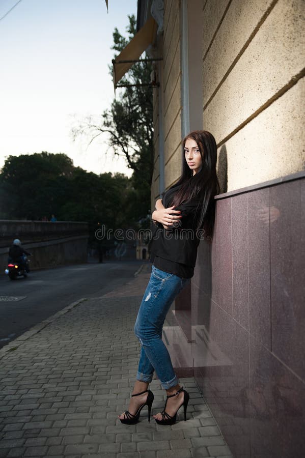 Woman Leaning on a Building Stock Image - Image of building, urban ...