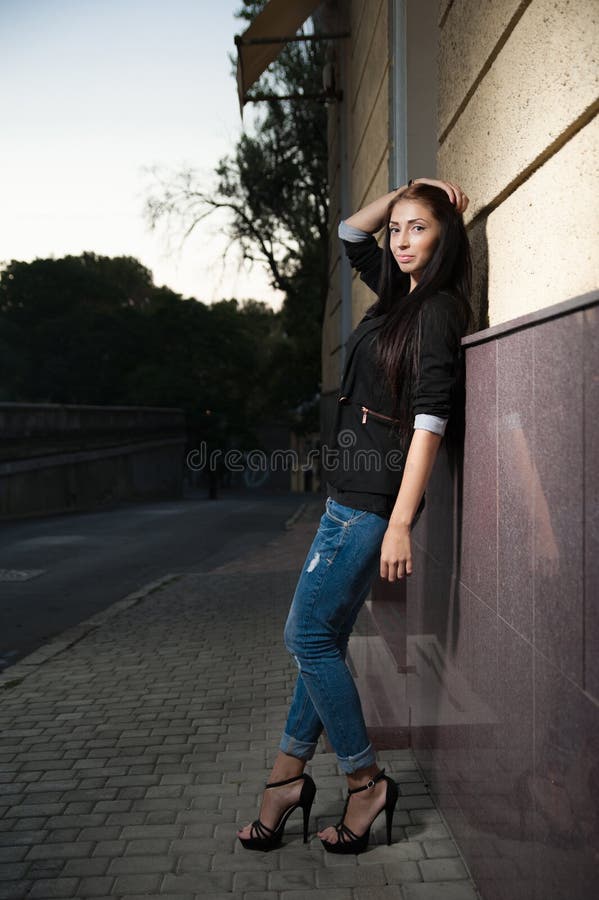 Woman Leaning on a Building Stock Image - Image of lifestyles, person ...