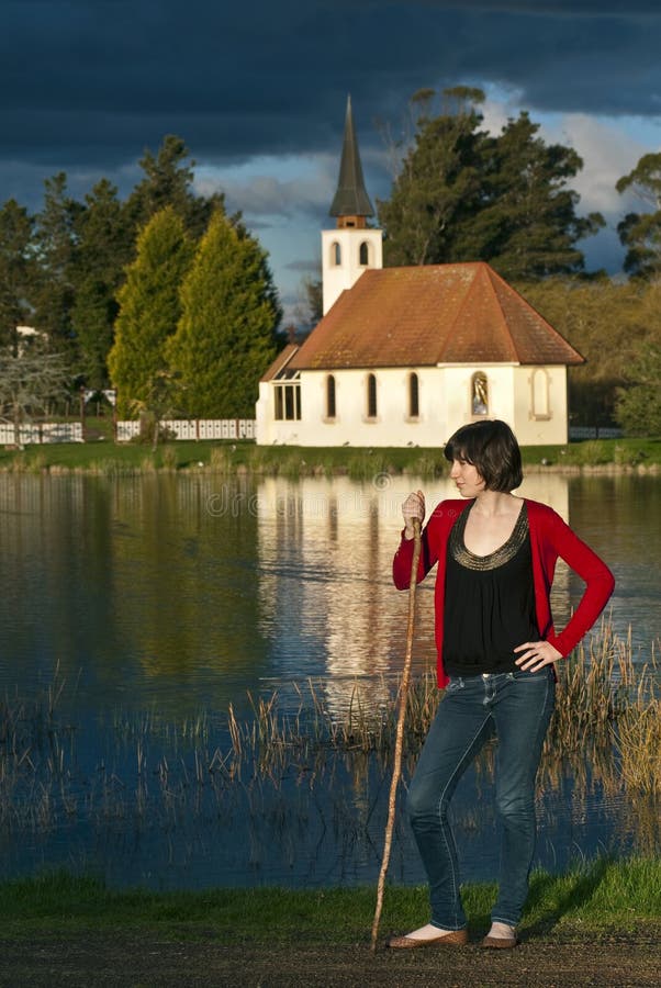 Woman Leaning on Stick by Church Stock Image - Image of light, jeans ...