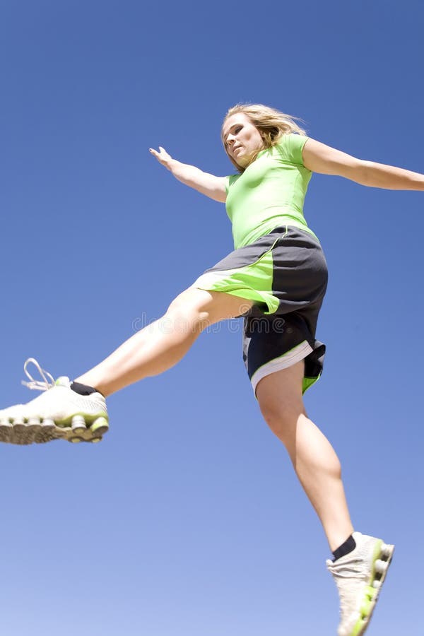 Woman Leaping with Blue Sky Stock Image - Image of exercise, green ...
