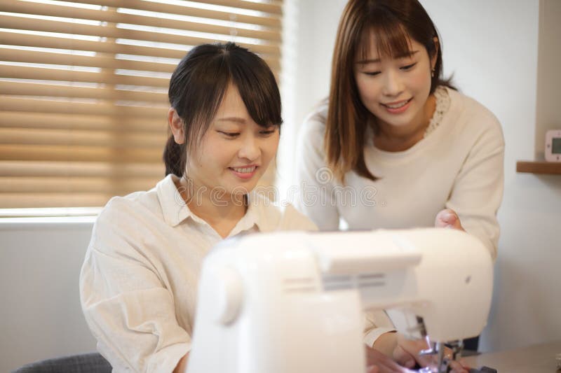 A Woman Learning How To Use a Sewing Machine Stock Photo - Image of ...