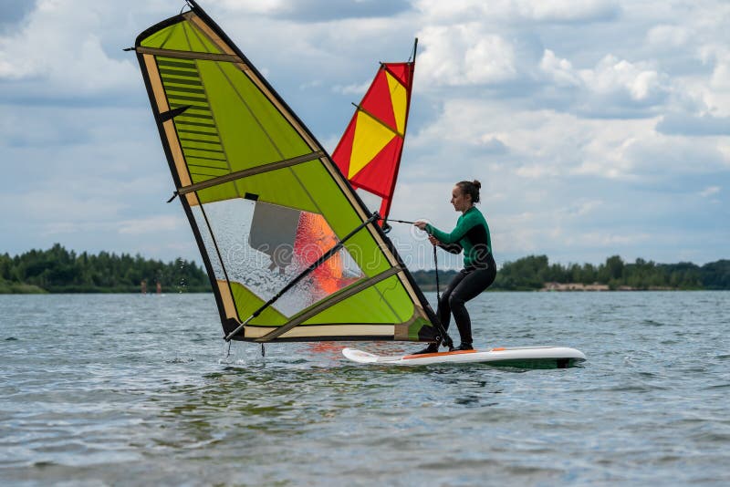 Woman Learning How To Windsurf Stock Photo - Image of girl, training ...