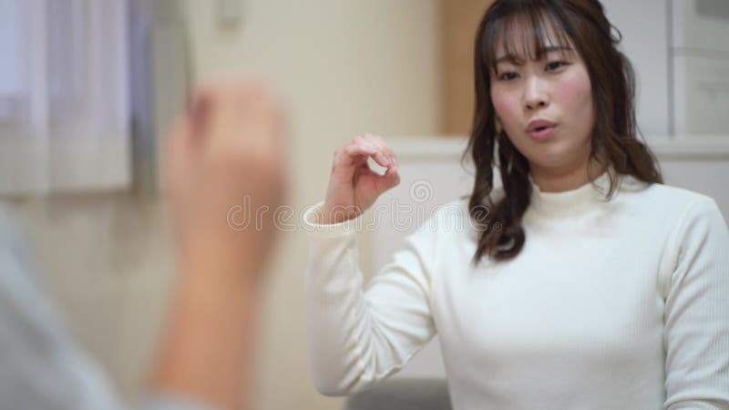 A Woman Learning Sign Language Stock Footage - Video of japanese, smile ...