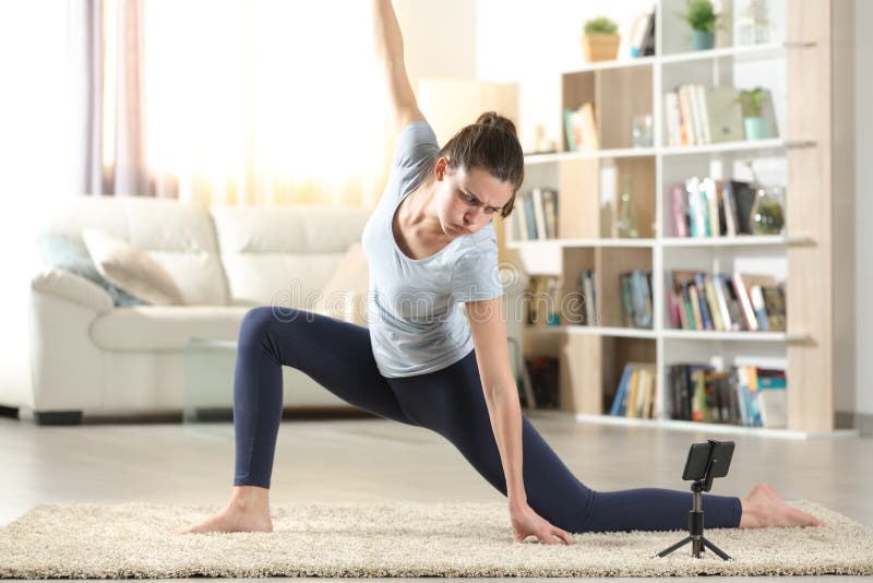 Woman Learning Yoga Poses Watching Tutorial on Phone Stock Photo ...