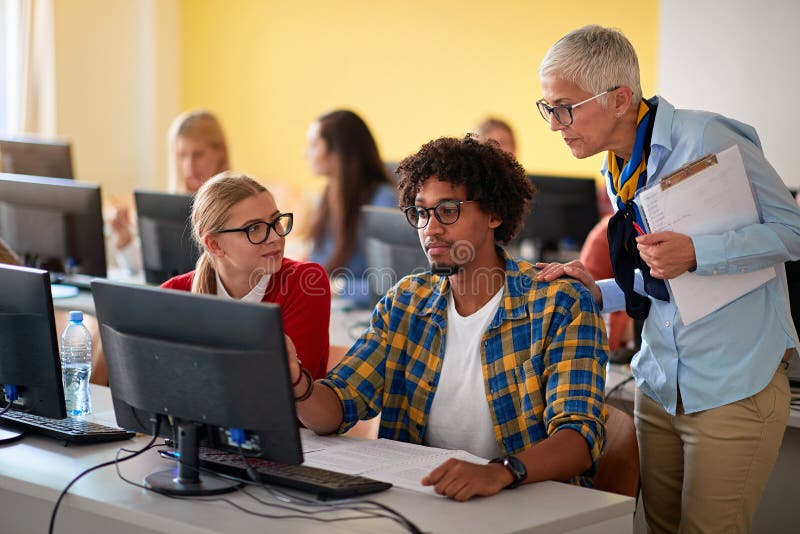 Woman Lecturer in Computer Class Assisting Student Stock Image - Image ...
