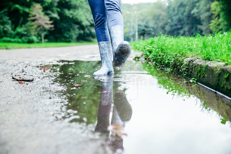 Woman Legs Walking by Puddle Stock Photo - Image of playful, protection ...