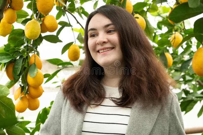 Woman in Lemon Orchard Smiling and Looking at Lemon Fruit Stock Photo ...