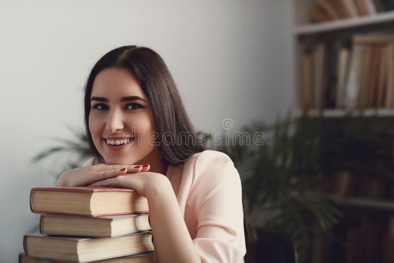Woman in the library stock image. Image of pile, attractive - 96275425