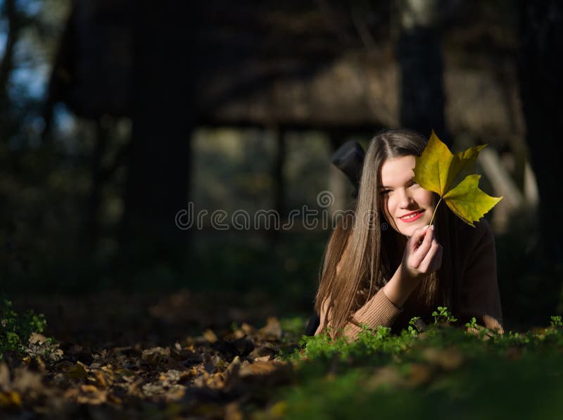 Woman Lie Prone in the Forest with Maple Leaf Stock Image - Image of ...