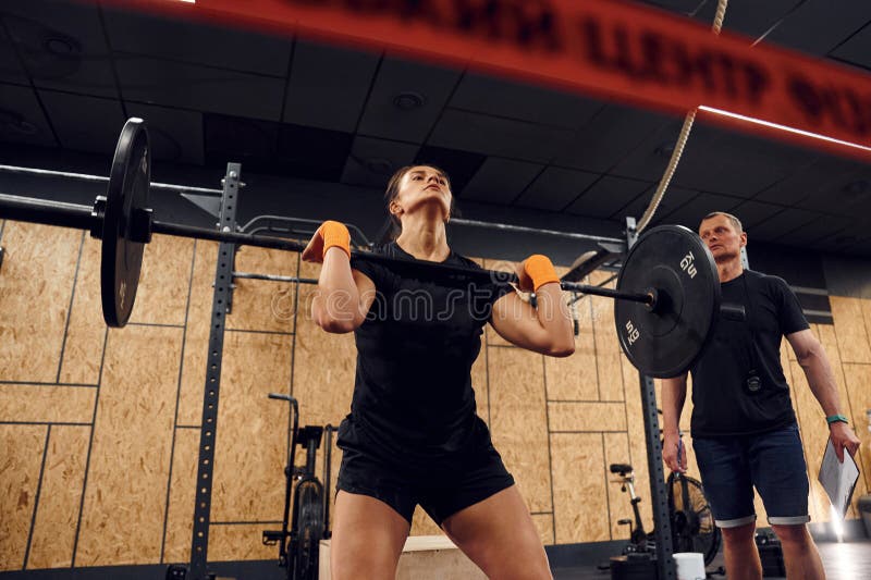 Woman is Lifting Barbell in the Gym Stock Image - Image of athletic ...