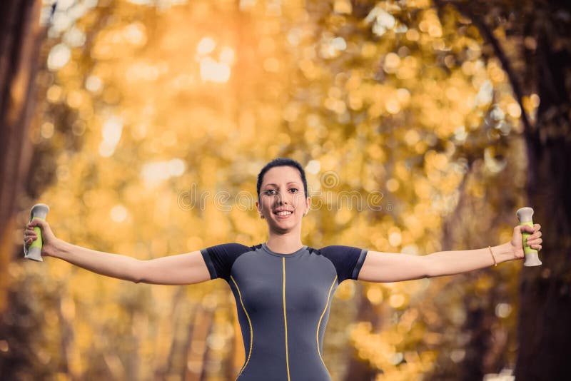 Woman Lifting Small Weights in the Park Stock Photo - Image of leisure ...