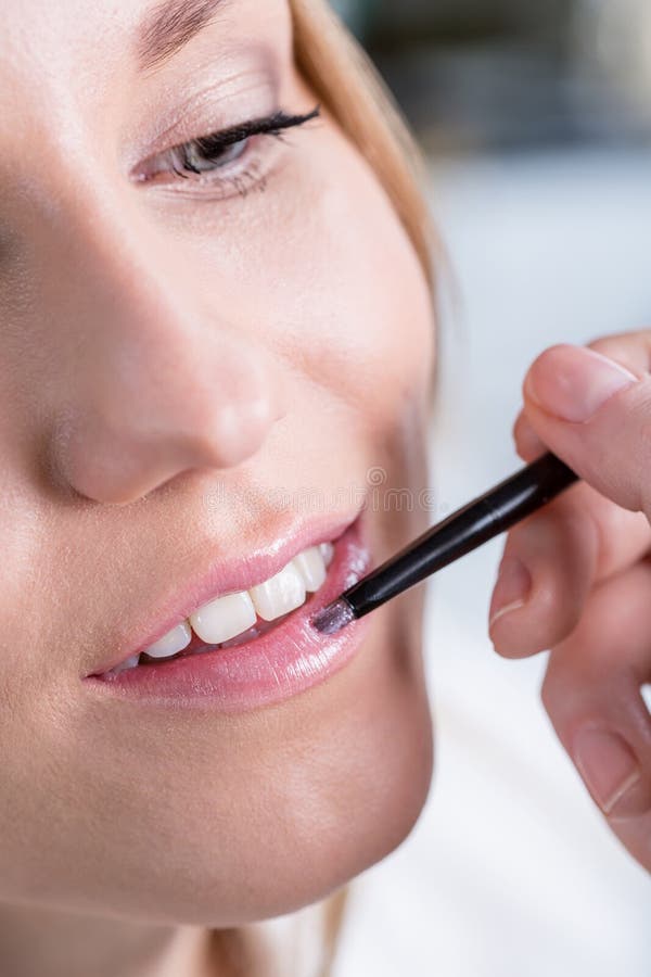 Woman during lips makeup stock image. Image of makeup - 46261145